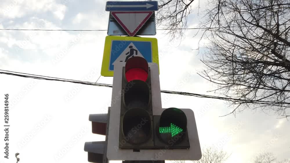 Traffic lights red, yellow, green, green arrow. Sign give way ...