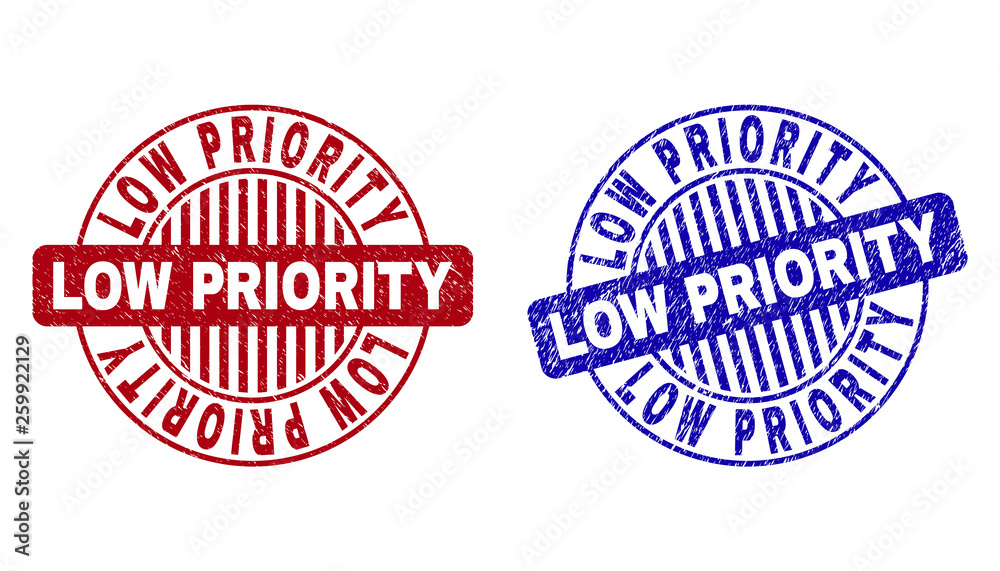 Grunge LOW PRIORITY round stamp seals isolated on a white background ...