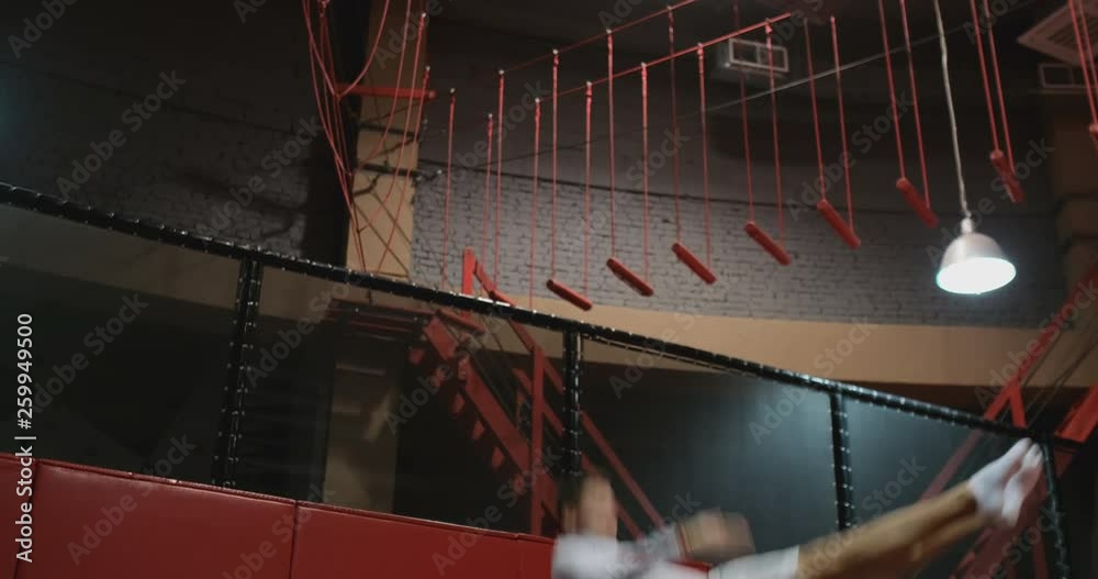 Acrobat gymnast jumping on a trampoline in the trampoline center in ...