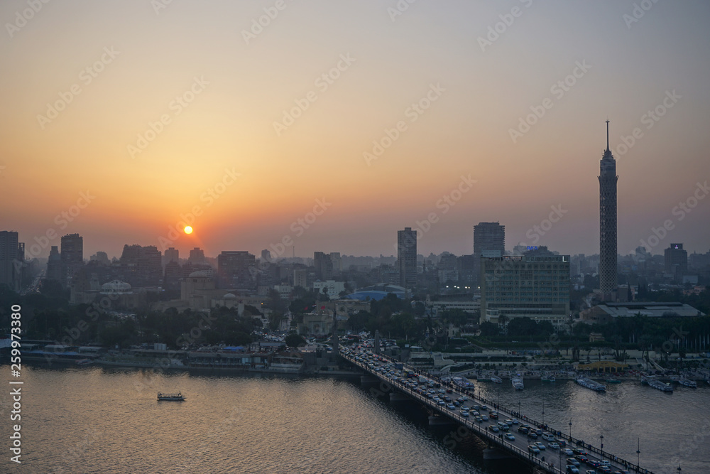 Cairo, Egypt: Cairo Tower and the Qasr el Nile Bridge at sunset. On ...