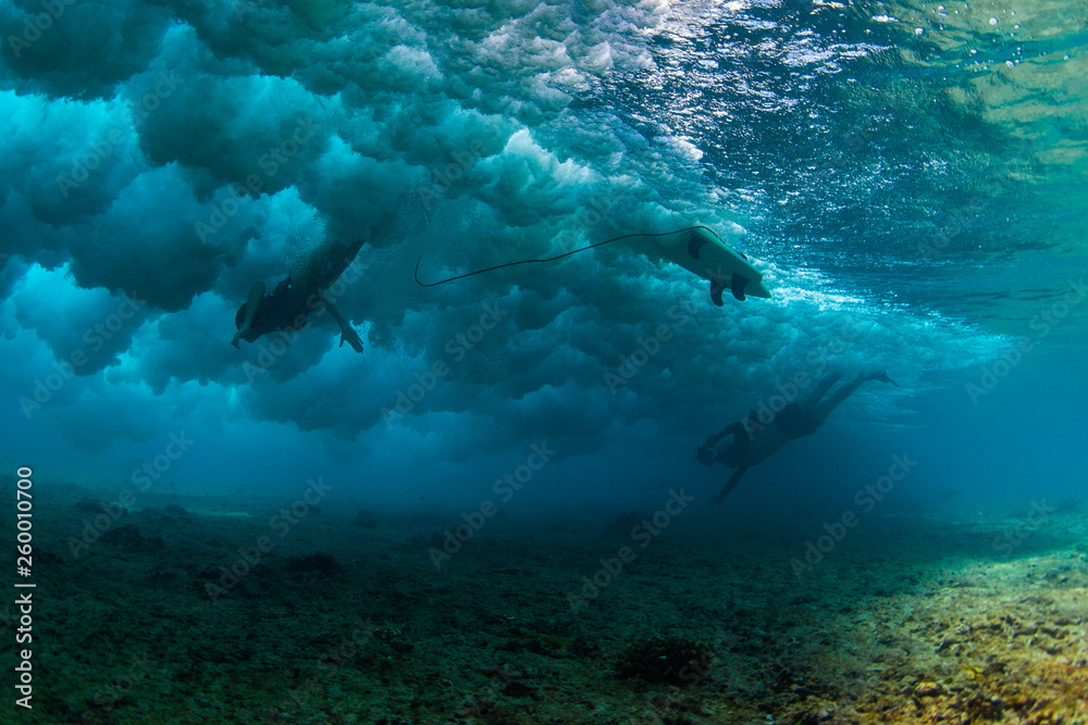 Underwater photographer takes photo of the female surfer diving under ...