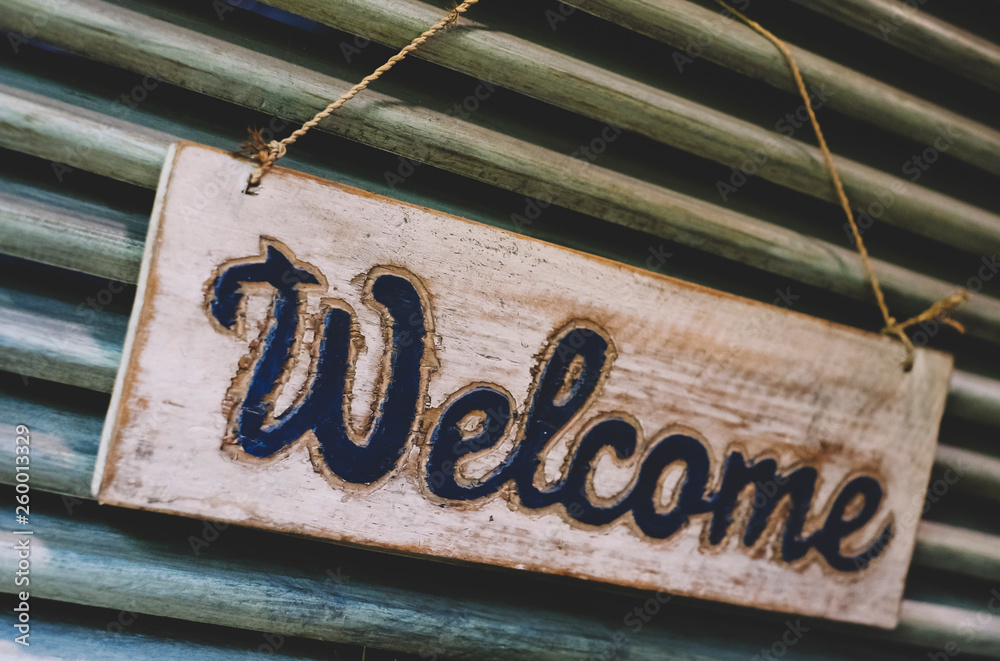 Rustic wood welcome sign hanging by rope on antique door Stock Photo ...