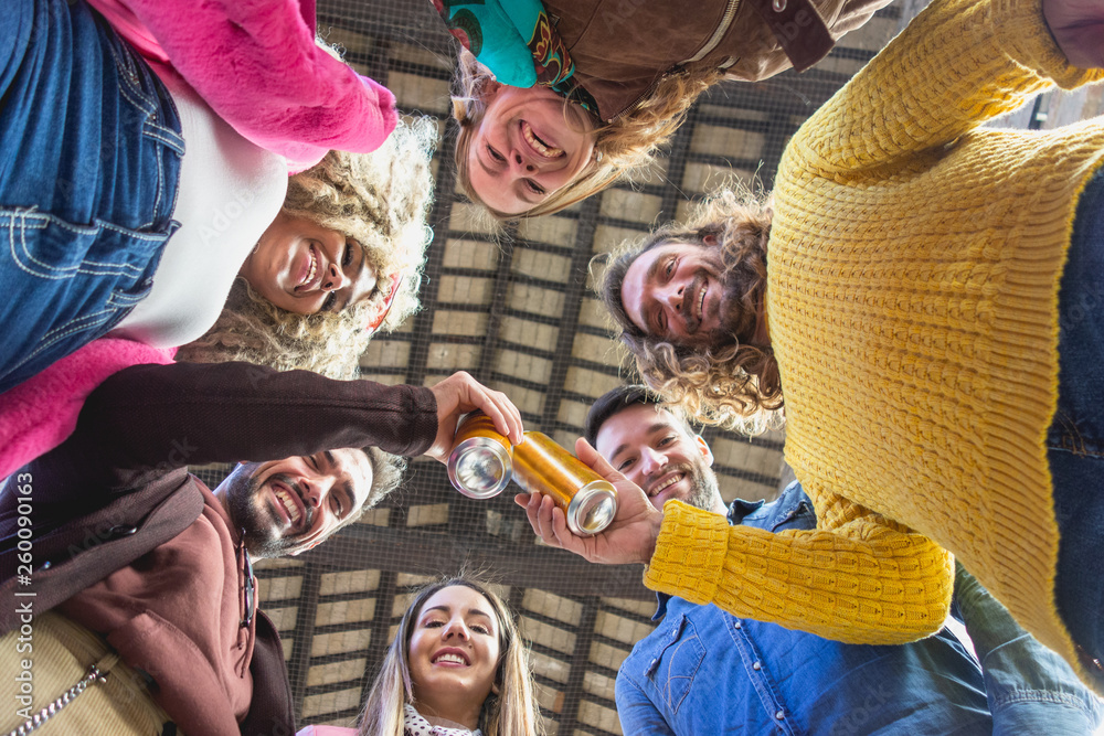 Multi racial group of people having fun time. Bottom up picture of ...