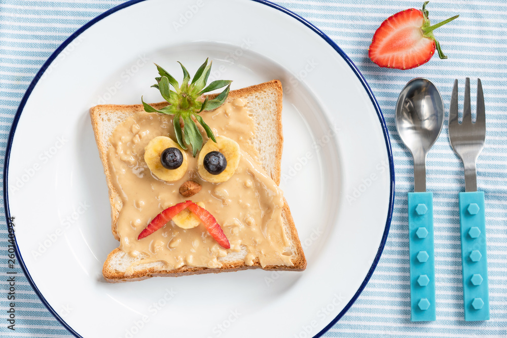 Toast with funny face for kids. Angry Bird face on peanut butter toast ...