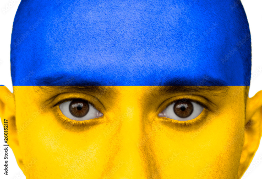 National flag Ukraine colored depicted in paint on a man's face close ...