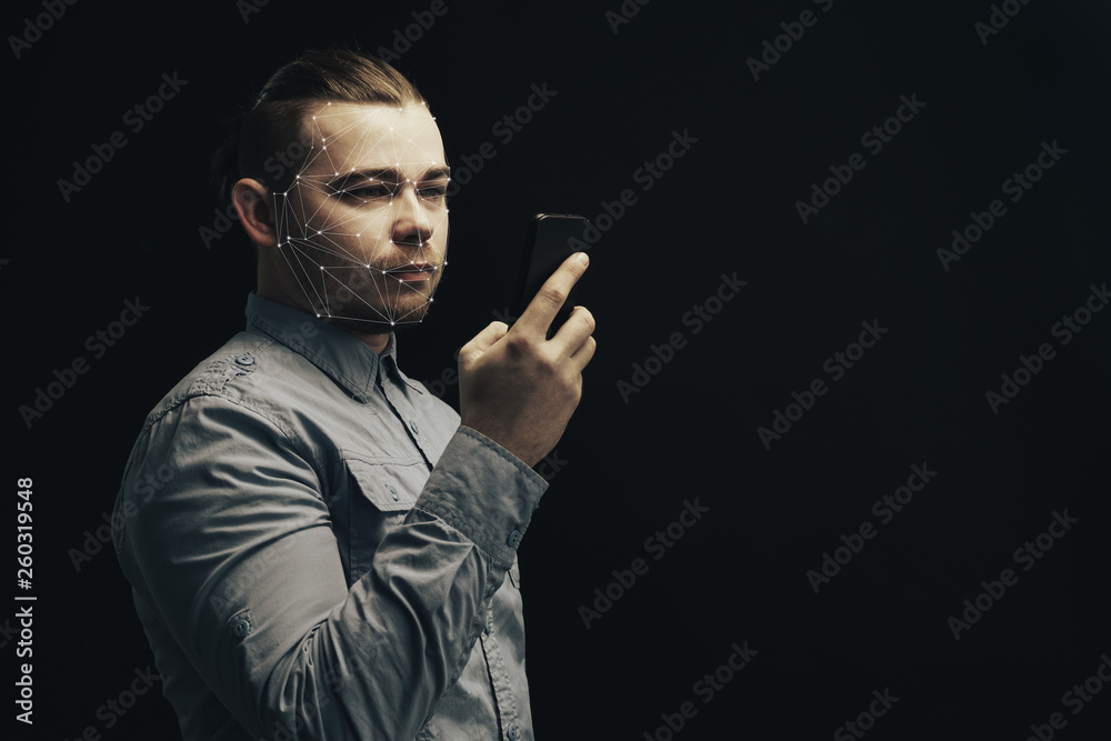 Facial recognition system, concept. Young man on the grey background ...
