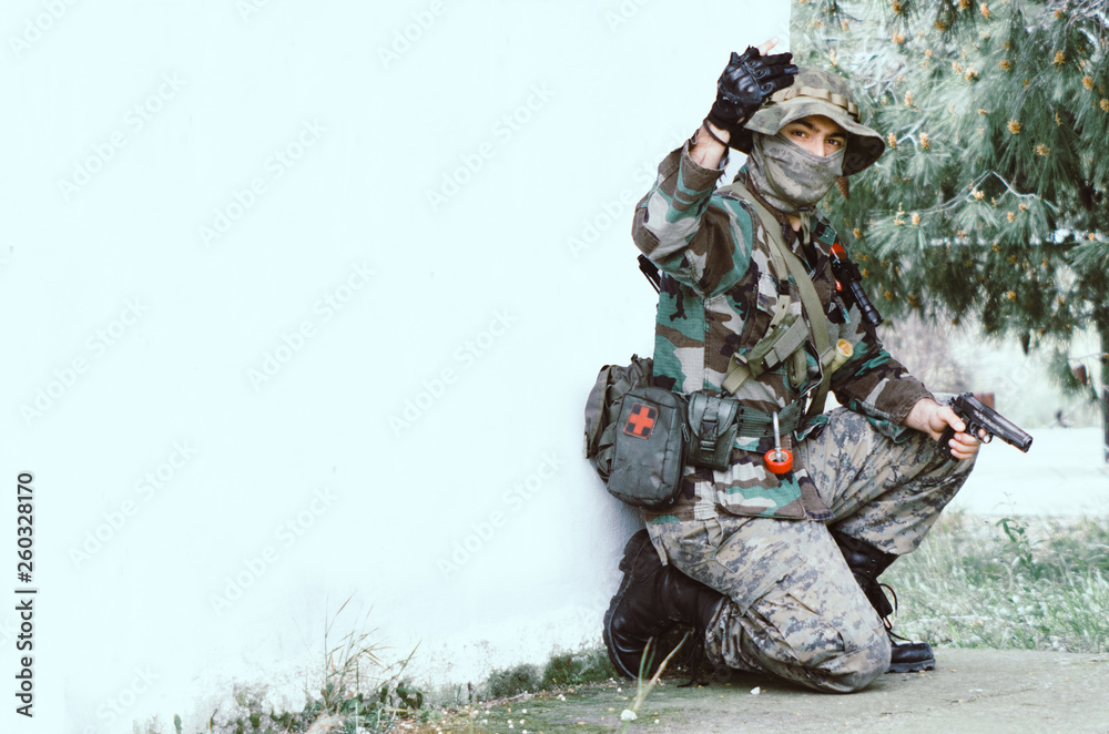 Special forces soldier holding rifle gun take cover behind a wall Hand ...