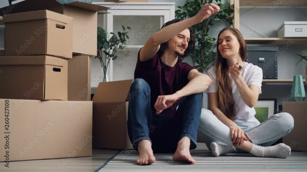 Young man house owner is giving keys to attractive girlfriend then ...