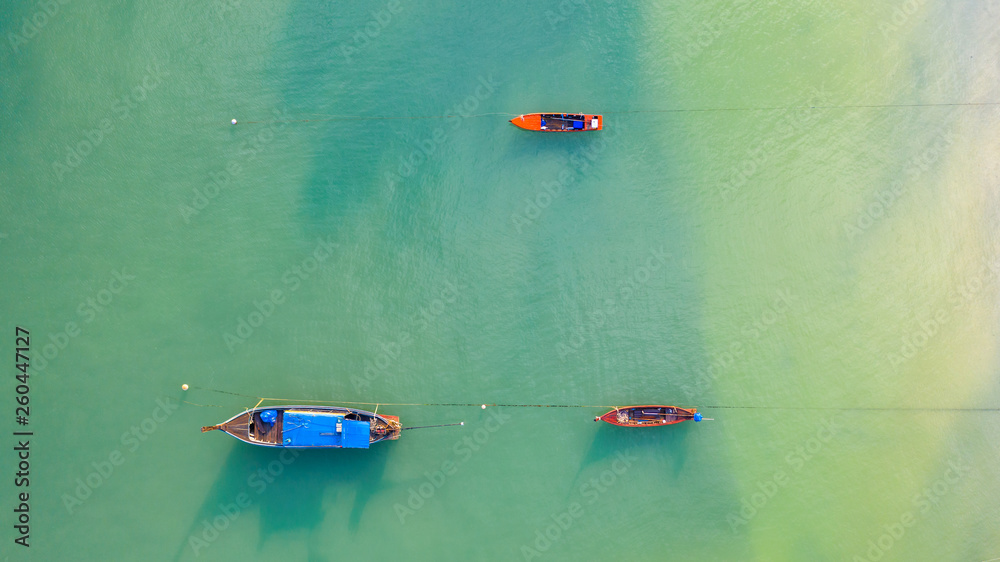 Aerial top view, Fishing boat, Tourist boat floating on a shallow clear ...