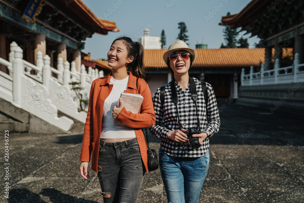 Travel tourist frienship. two smiling girls backpackers walking in ...