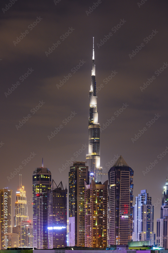 Poster Stunning view of the illuminated Dubai skyline during sunset ...