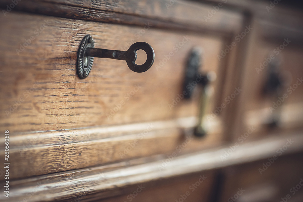 Vintage. Old chest of drawers with a key in the keyhole. Shallow DOF ...