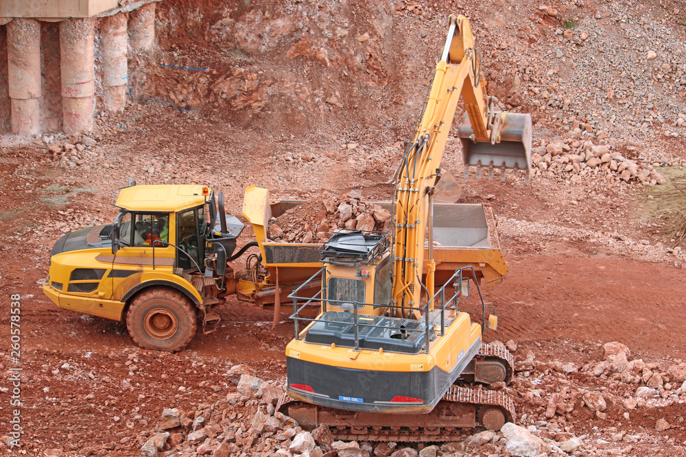 digger loading a dump truck on a road construction site Stock Photo ...