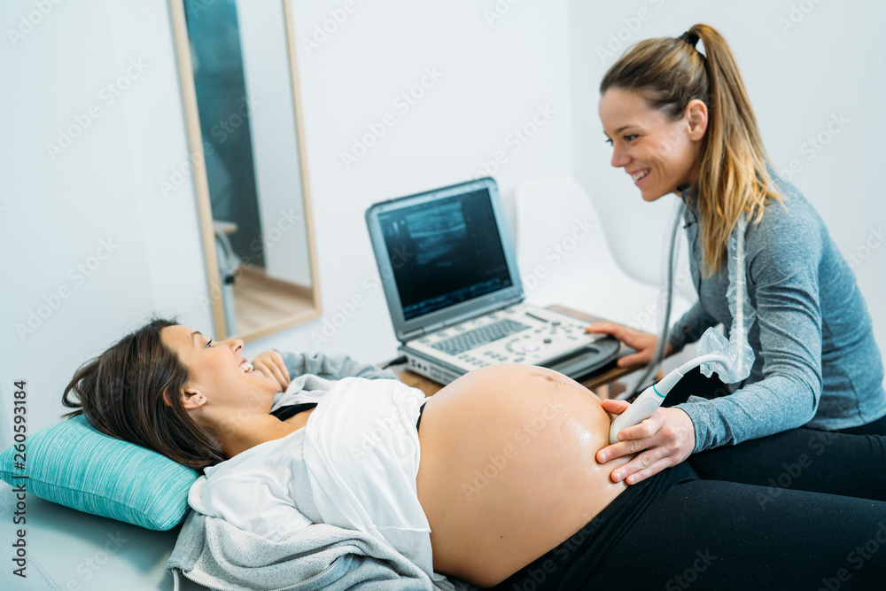 Doctor performing an ultrasound scan on pregnant woman Stock Photo ...