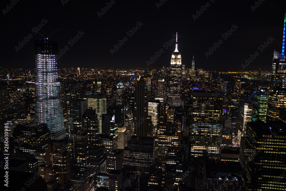 Night time aerial view of Manhattan in New York City showing the ...
