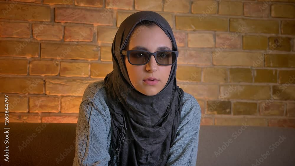 Closeup shoot of young attractive muslim female in hijab watching a 3D ...