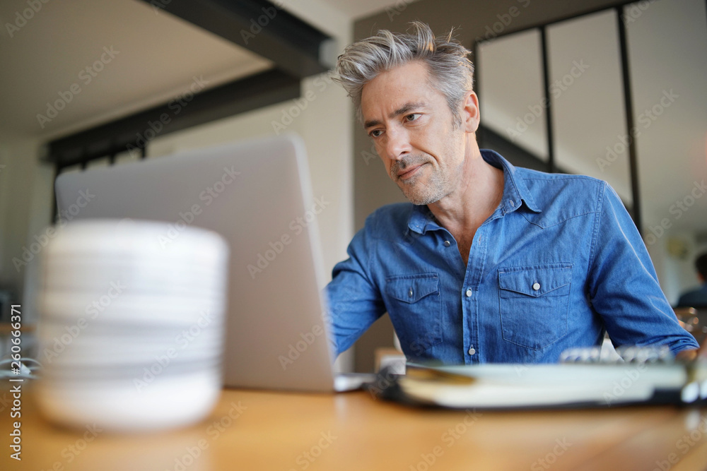Mature man working from contemporary home Stock Photo | Adobe Stock
