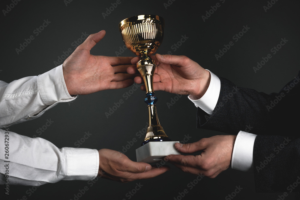 Award ceremony concept. Businessman is giving a golden cup award trophy ...