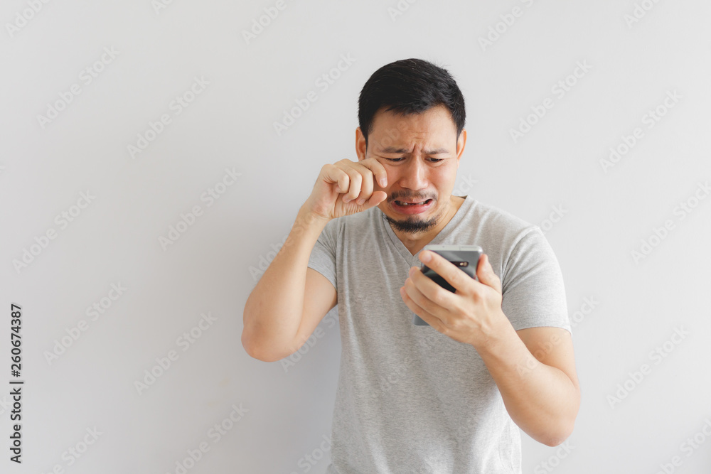 Man cry and sad with what show on the smartphone. Stock Photo | Adobe Stock
