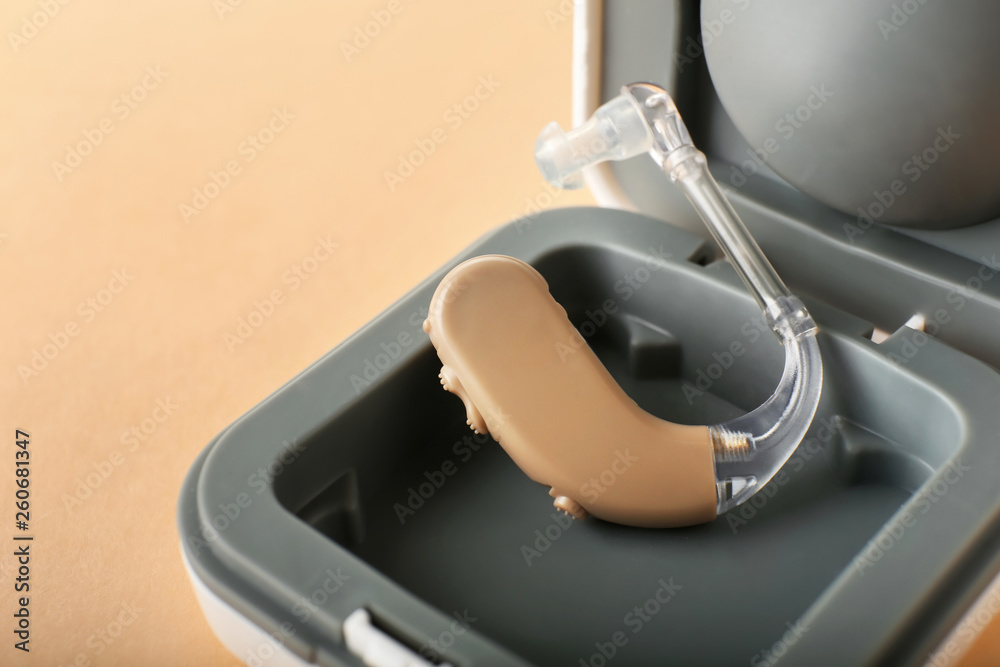 Box with hearing aid on color background, closeup Stock Photo | Adobe Stock