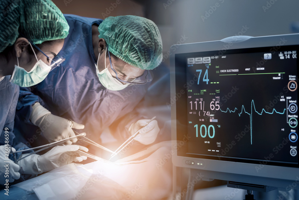 Team of doctors or surgeons with electrocardiogram monitor in hospital ...