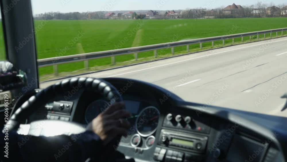 Bus driver behind the wheel of long-distance coach. Man driving a ...