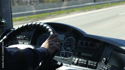 Bus driver behind the wheel of long-distance coach. Man driving a ...