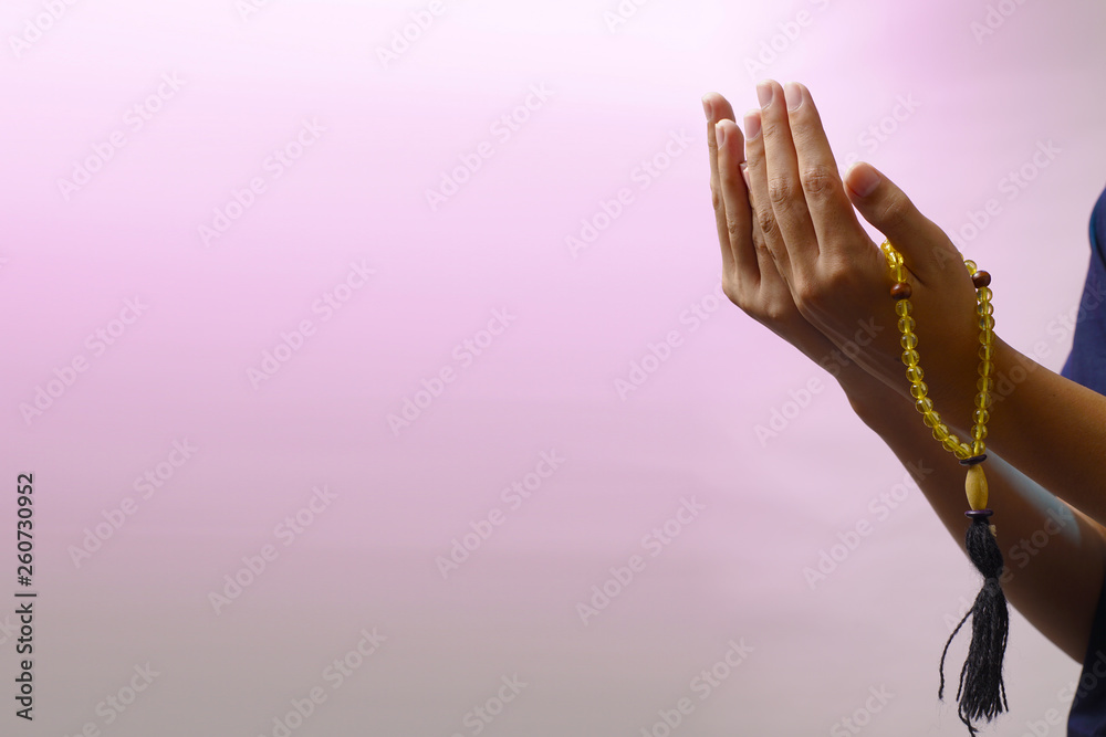 Pray. Lifting both open arms decorated with prayer beads to pray to God ...
