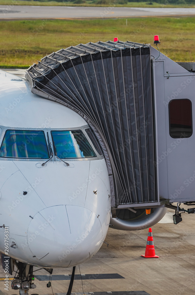 Jetway connected to the airplane for boarding passengers. Boarding ...