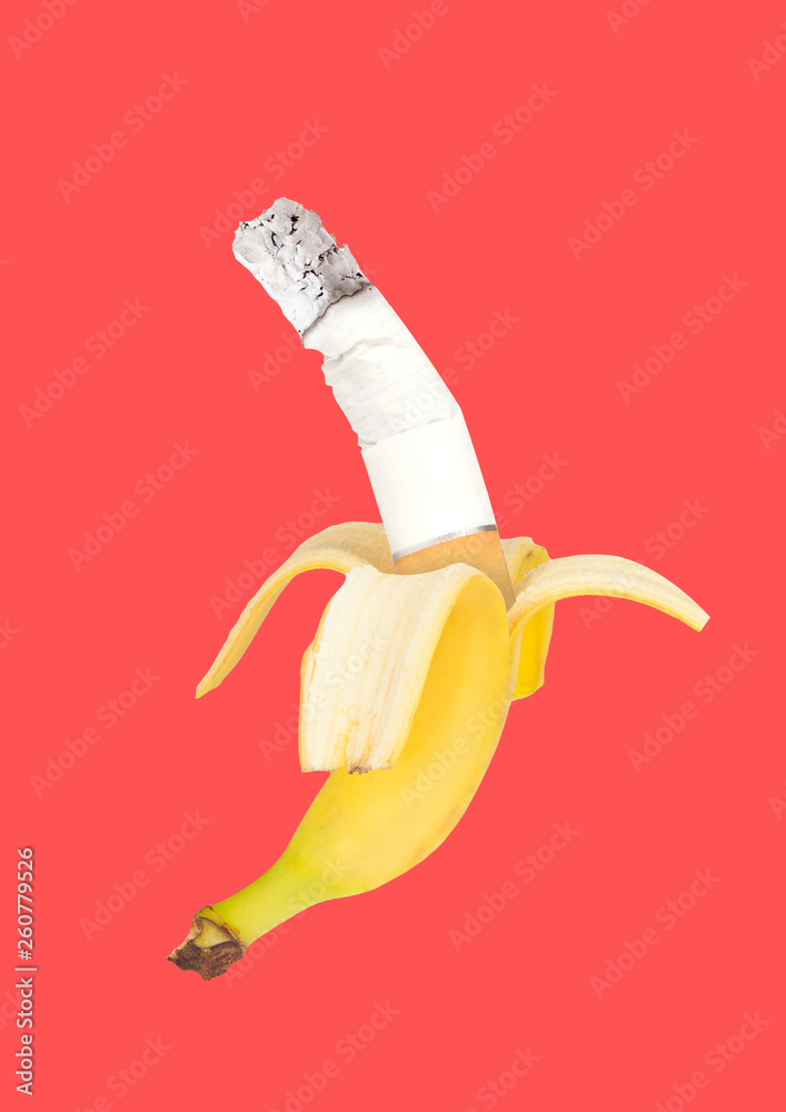 Taste of breking habit. Banana with cigarettes inside against bright ...