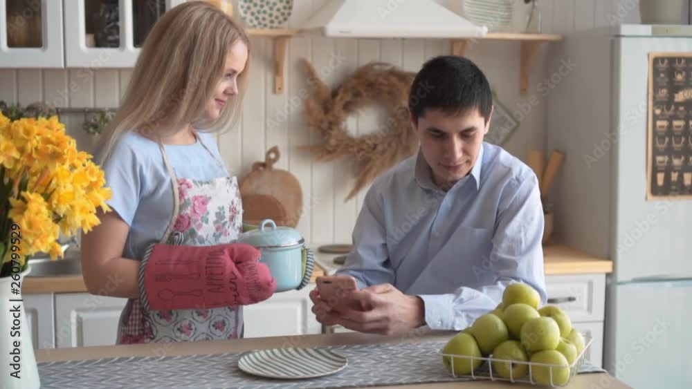 Young and happy couple in the kitchen. Happy couple in the kitchen. A ...