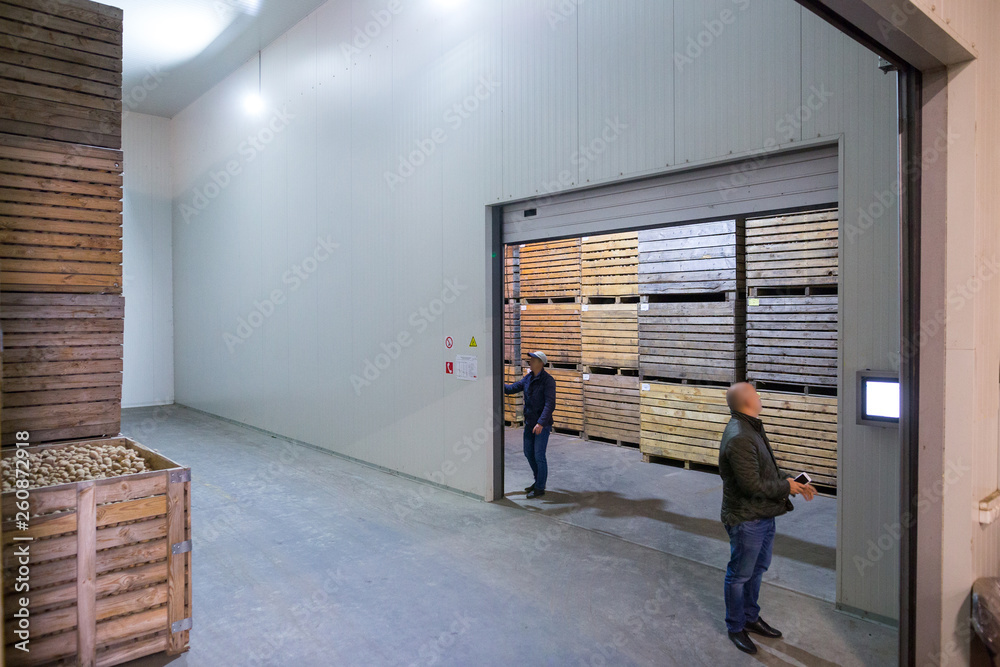 Potatoes storage. Crops warehouse. Dry cool storage. Stacked wooden ...