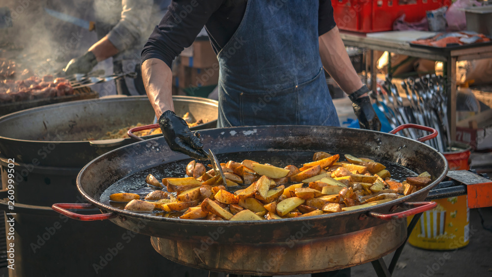 street food. potato dipes. potatoes by peasant. the process of cooking ...