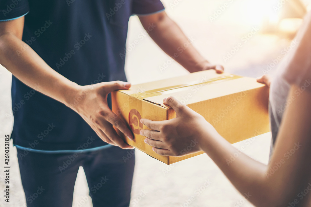 Delivery man delivering holding parcel box to customer Stock Photo ...