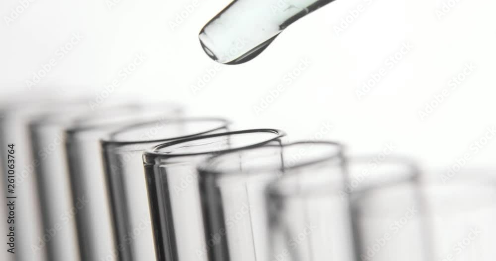 Medical laboratory test, pipette drips transparent chemicals into test ...