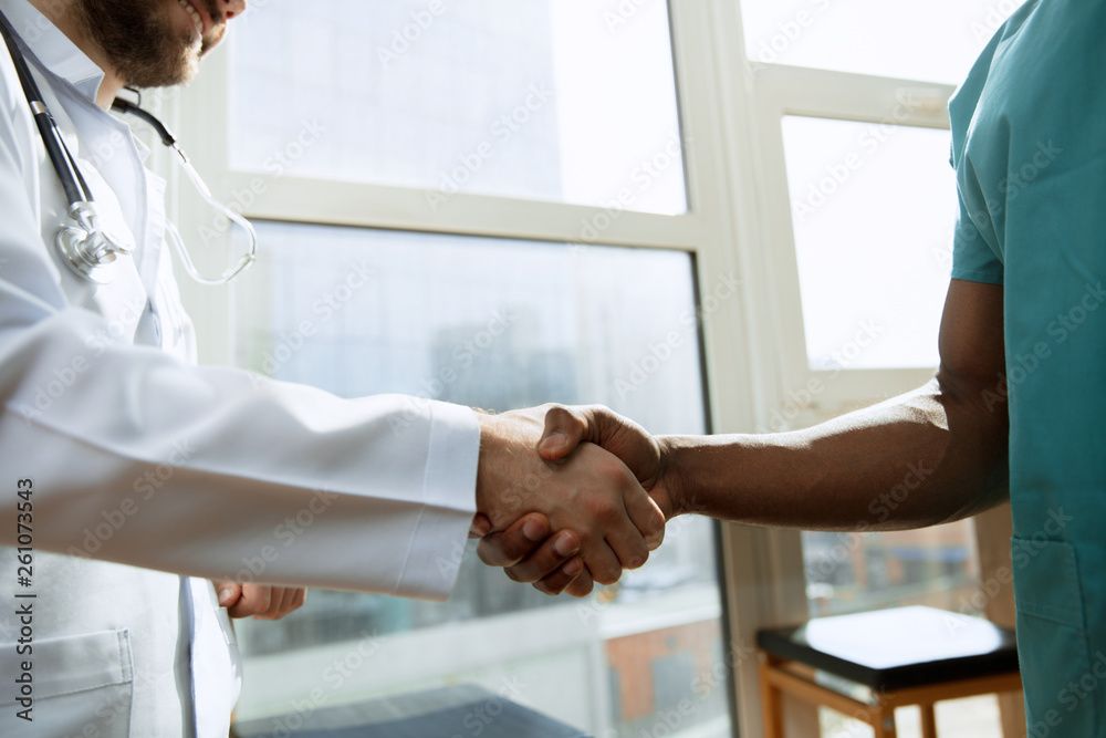 Deal. Concept of collaboration in medicine. Close up photo of two ...