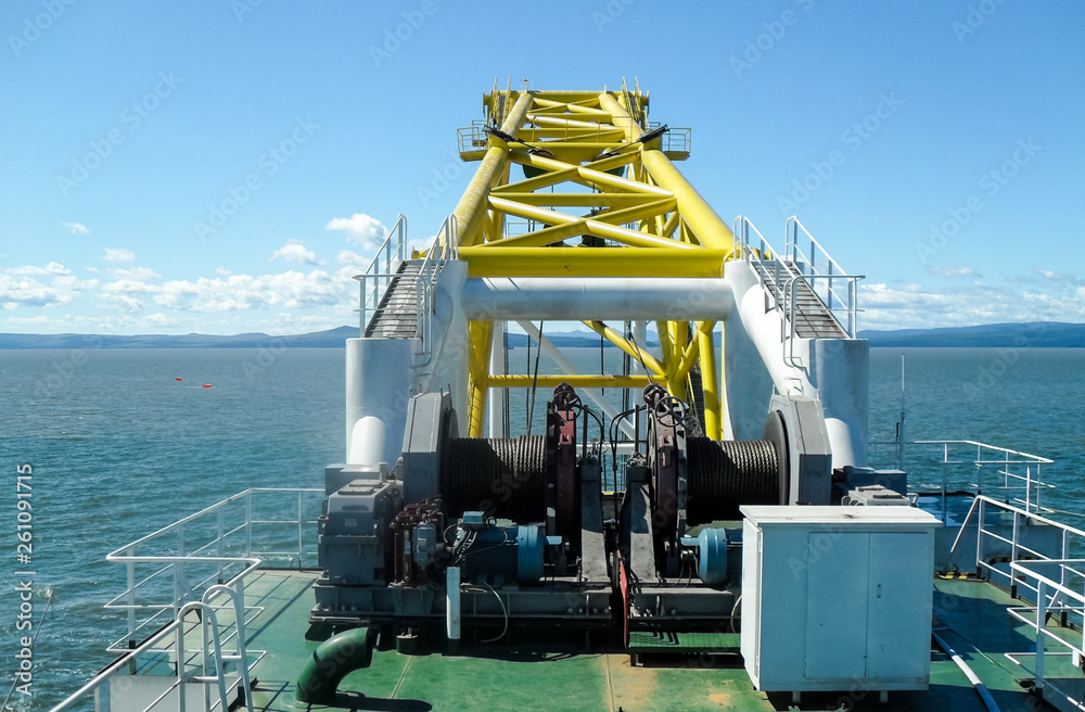 Laying of pipes with pipe-laying barge crane near the shore. Descent of ...