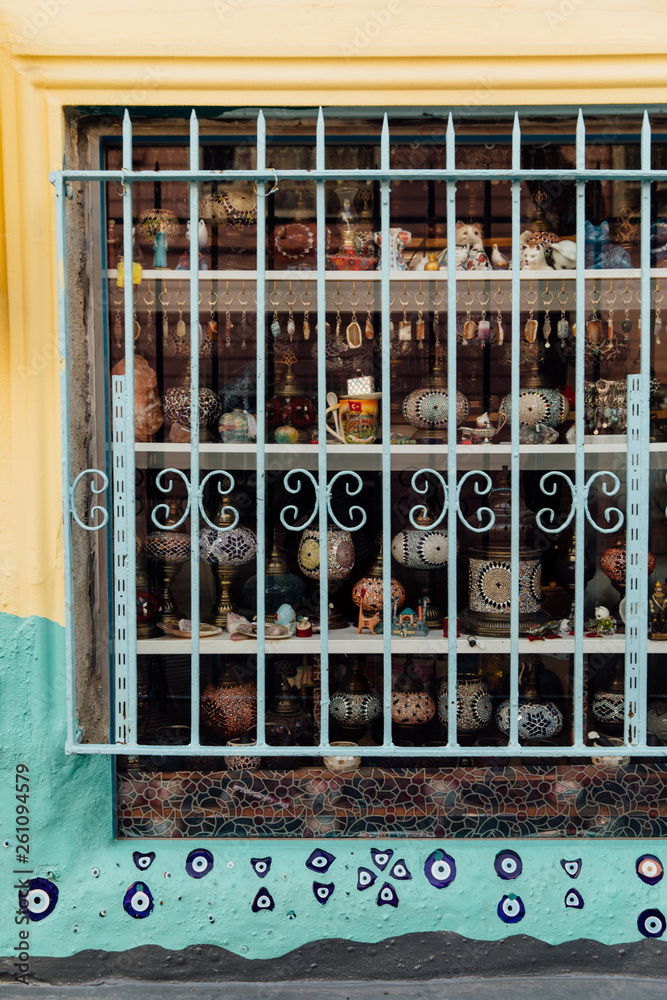 Trinkets in a window with Turkish evil eyes around the edge Stock Photo ...