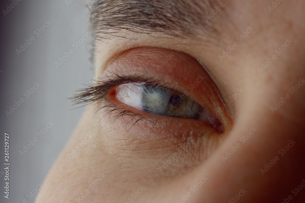 men's narrowed eyes. Direct tired look in the frame close-up. serious ...