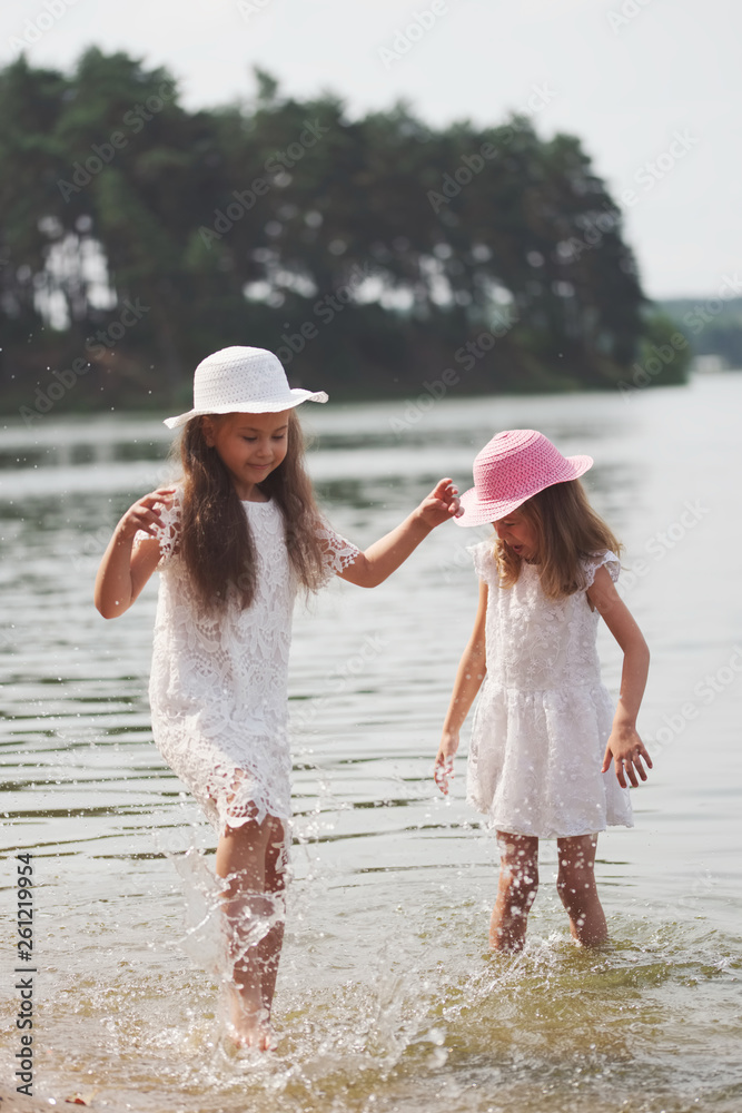 cute happy little girls in sumer lake Stock Photo | Adobe Stock