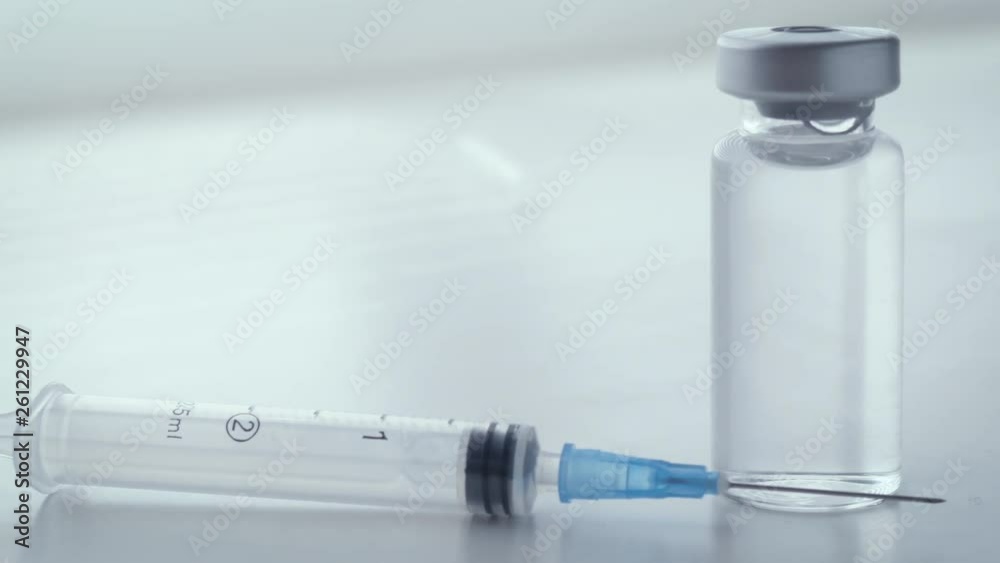 Closeup of a doctor filling a syringe with vaccines. Needle of the ...
