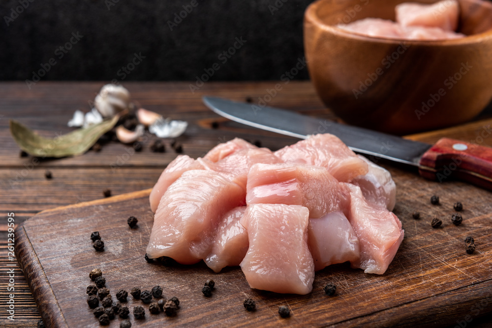 Diced raw chicken breast or fillets on dark wooden background. Stock ...