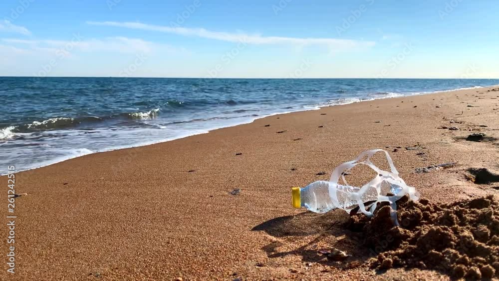 Plastic pollution. A plastic bottle and a six pack plastic rings on the ...