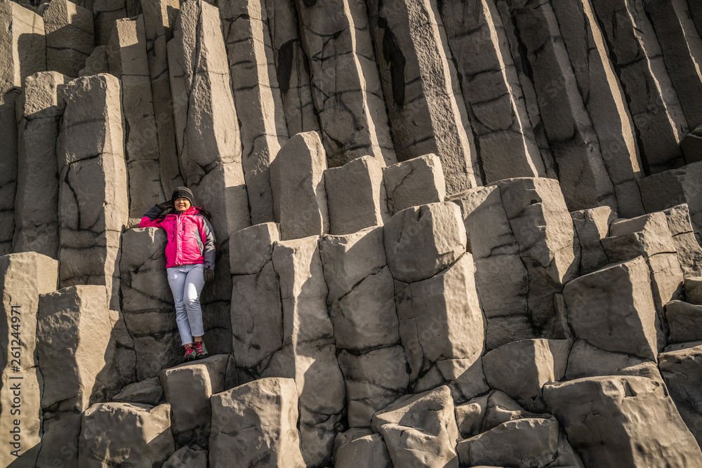 Traveler travel to unique volcanic rock formation on Iceland black sand ...