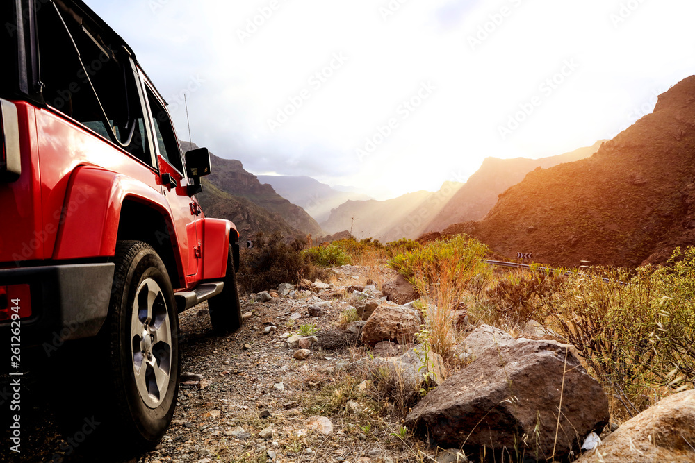 Red summer car on mountains road and summer sunset time. Stock Photo ...
