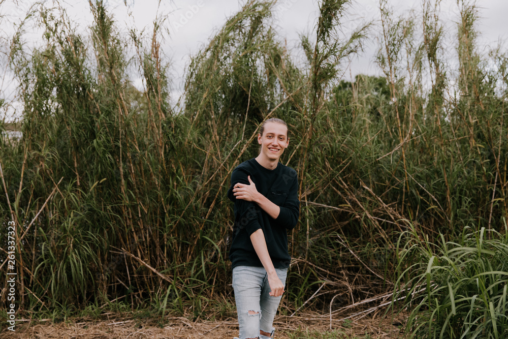 Tall and Handsome Young Man with Long Hair Pulled Back Modeling in ...