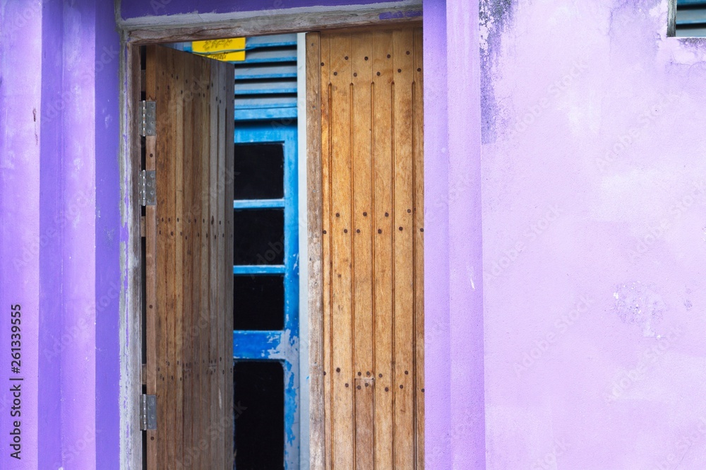 Entrance of a violet house with a wooden door (Ari Atoll, Maldives ...