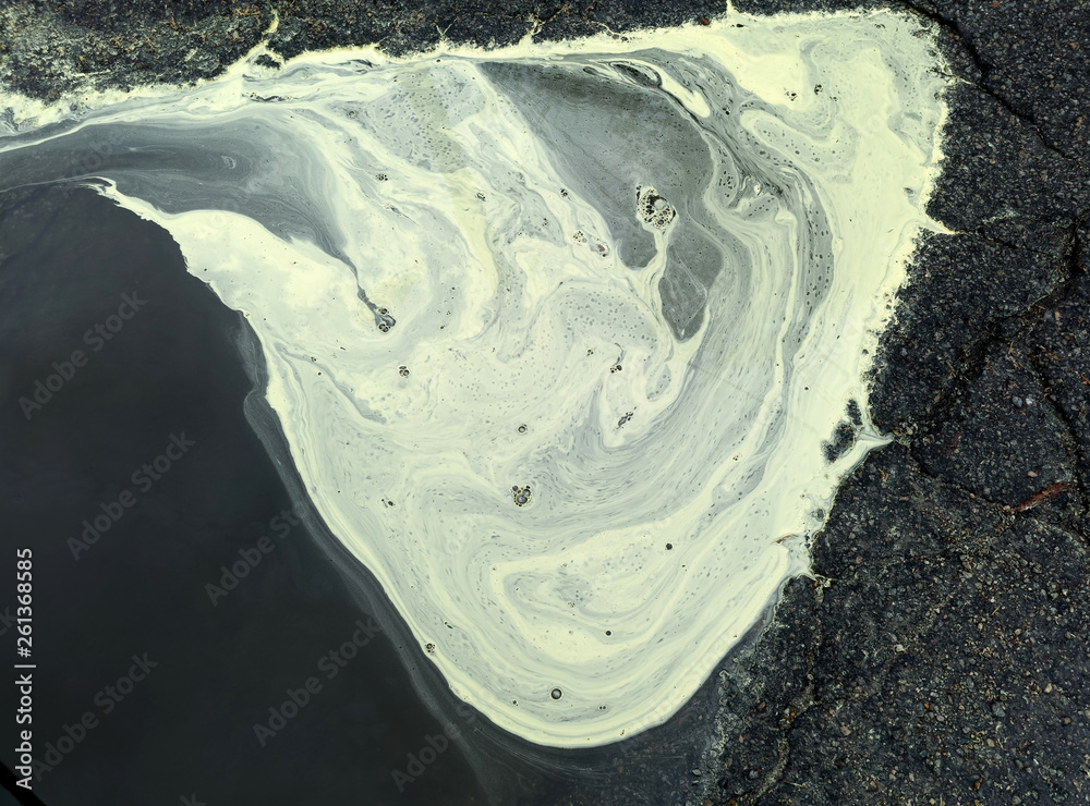 It looks like a polluted industrial site, but it's a rain puddle filled ...