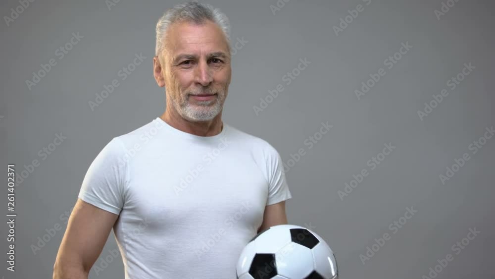 Aged athletic male playing with soccer ball, football coach, active ...