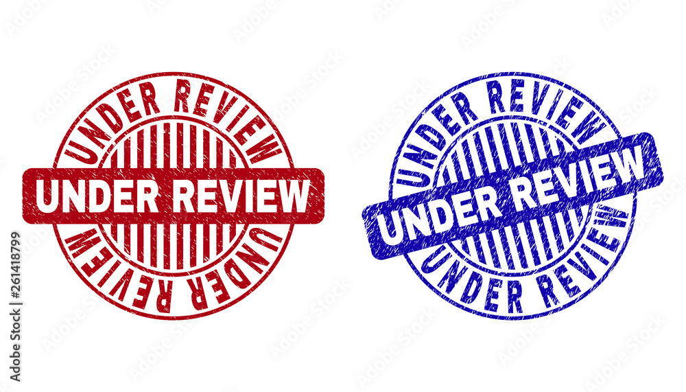 Grunge UNDER REVIEW round stamp seals isolated on a white background ...